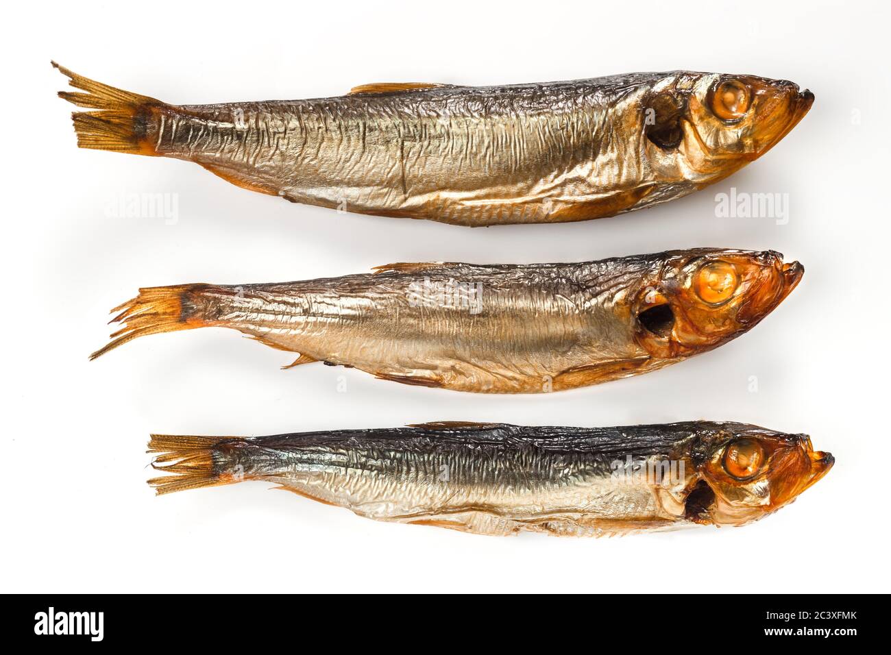 Three fish smoked sprat golden color on a white background Stock Photo ...