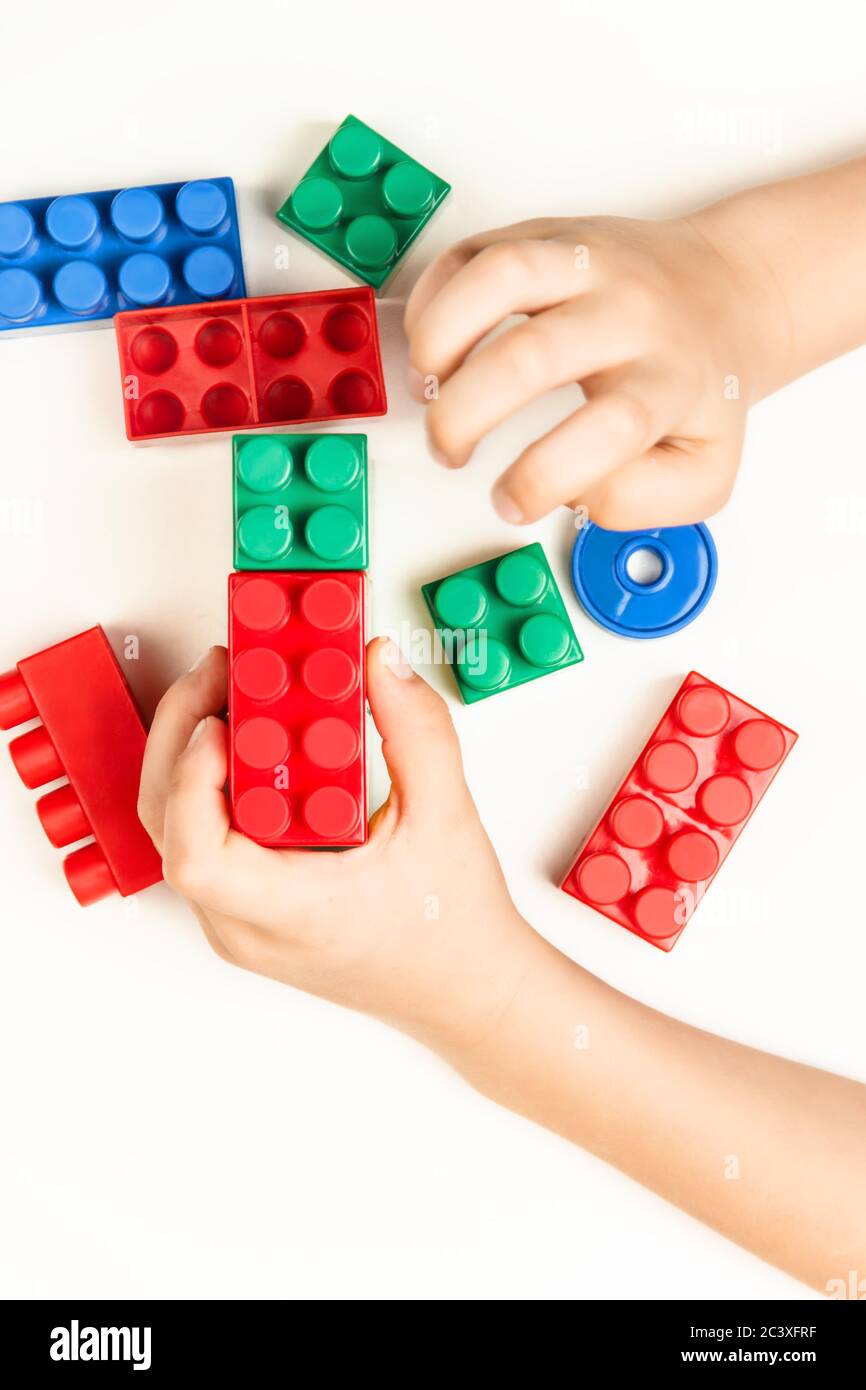 Children's hands collect the designer from cubes Stock Photo - Alamy