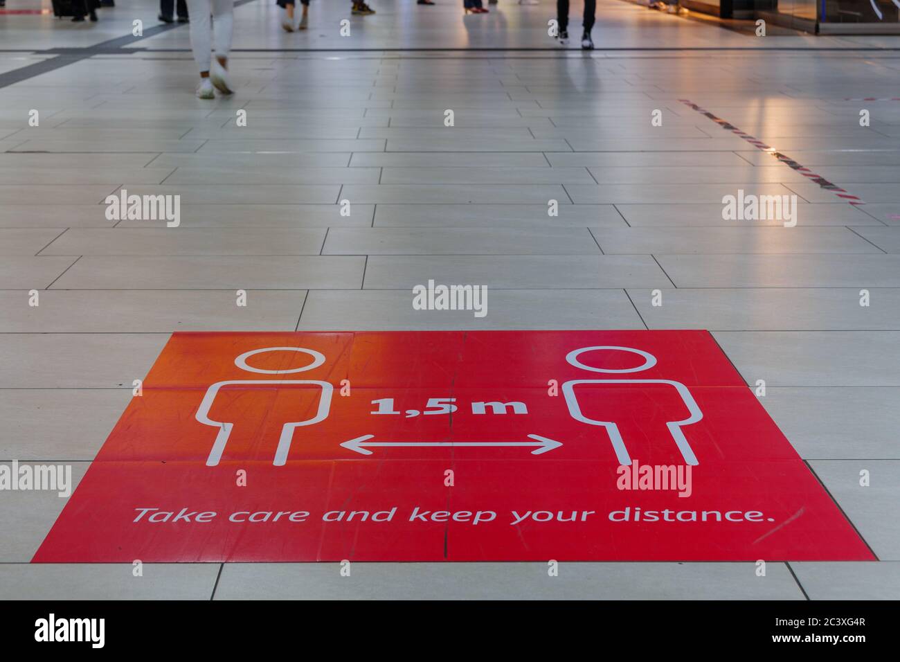 " Keep your distance", on red rectangular caution sign on the floor ...