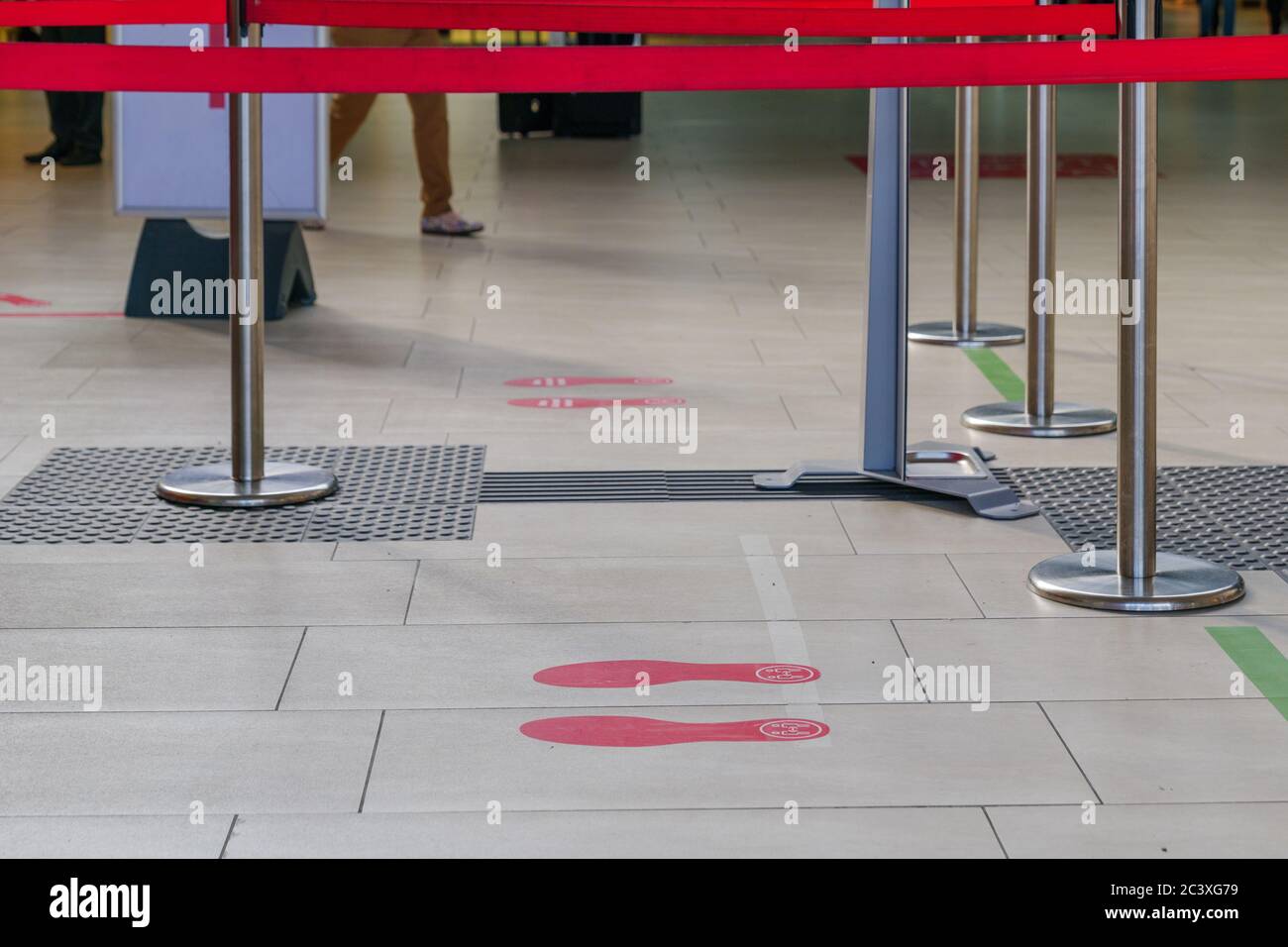 Red feet shape sticker sign on the floor for caution people do Social ...