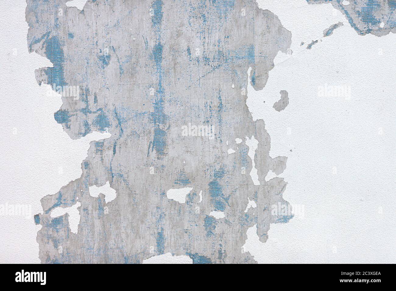 White shabby wall surface with peeling plaster and paint. Building ...