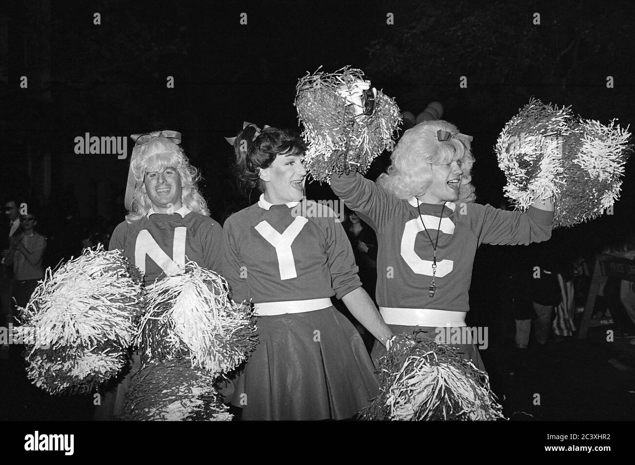 Three NYC cheerleaders with poms at the Greenwich Village Halloween ...