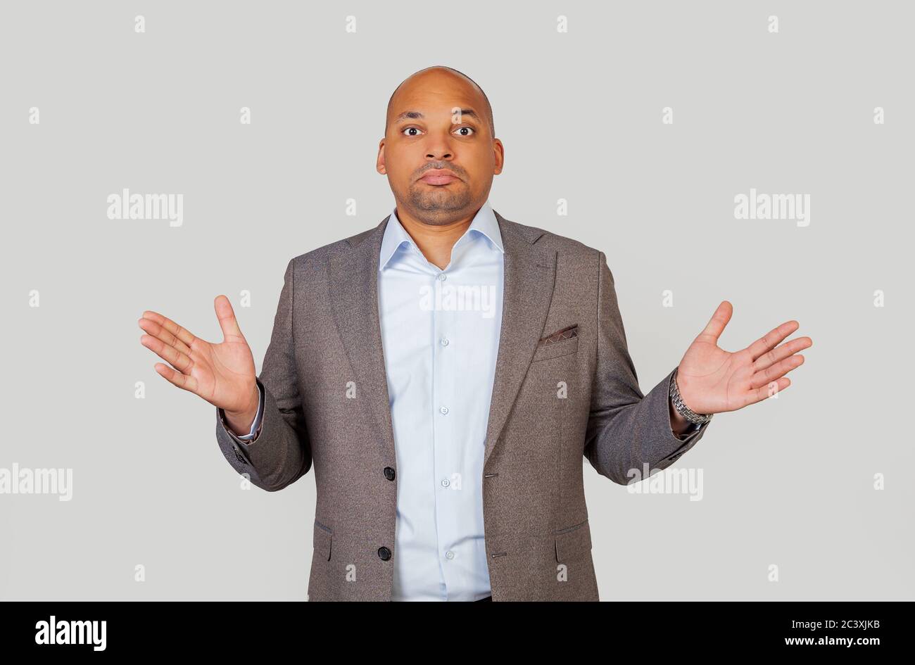 Puzzled embarrassed, black African-American young man, shrugging his ...