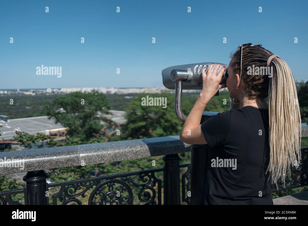 young tourist looking at sightseeing observation binocular Stock Photo ...