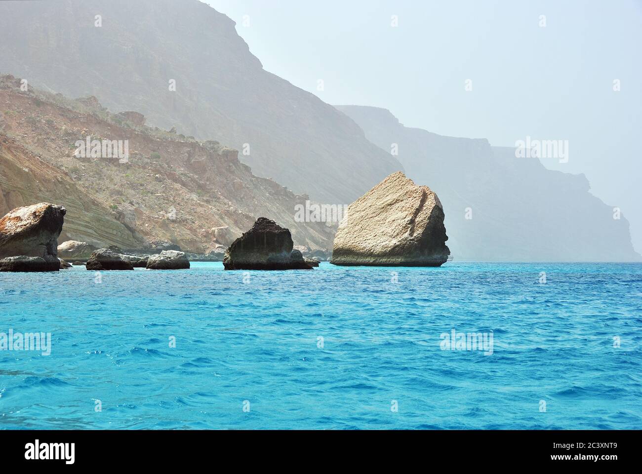 Cliffs above azure water of the Arabian Sea nearby Ras Shuab, Shuab Bay ...