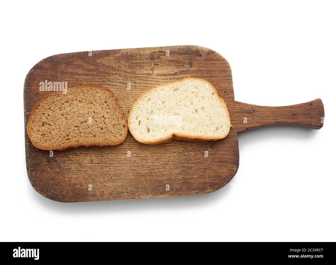 two slices of bread on a brown wooden board isolated on white ...