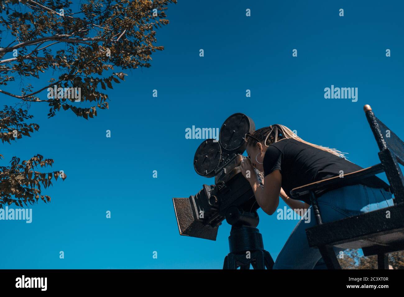 female cinema director looking at camera viewfinder Stock Photo - Alamy