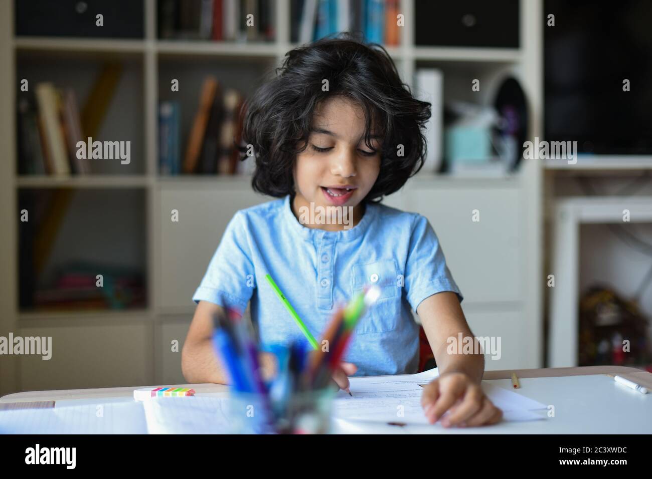 young boy doing his homework at home Stock Photo - Alamy