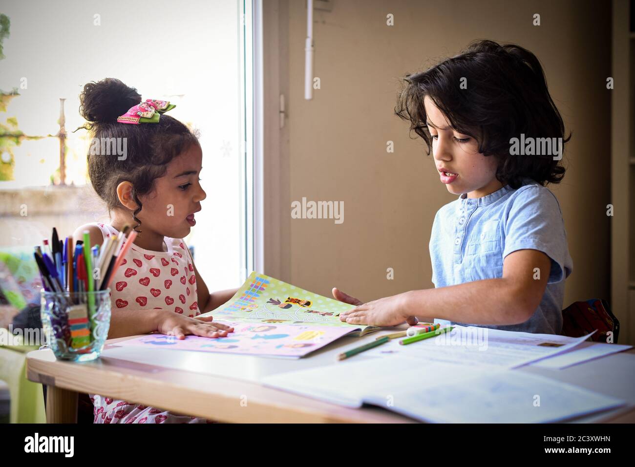young children doing their homework at home Stock Photo - Alamy