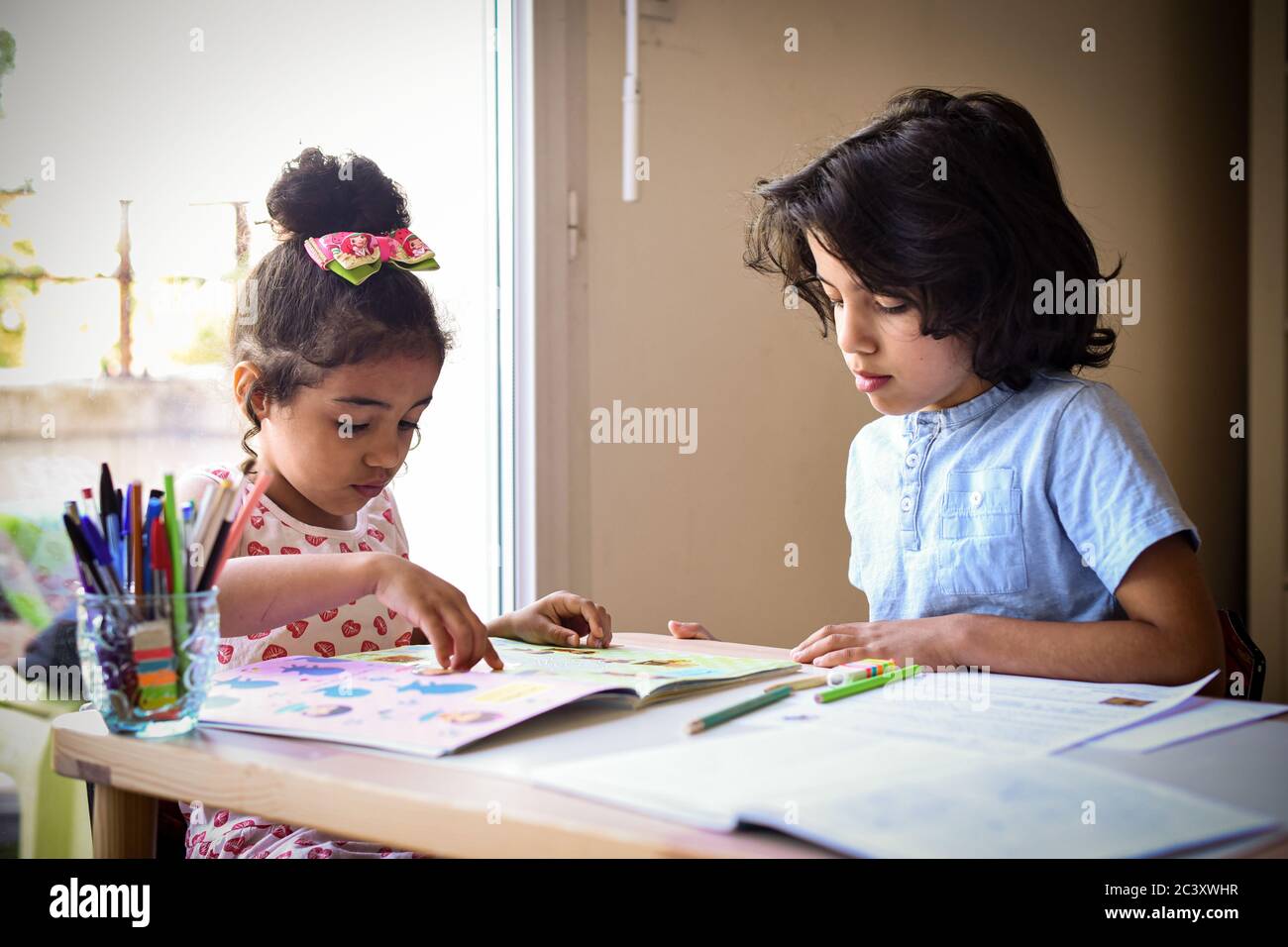 young children doing their homework at home Stock Photo - Alamy
