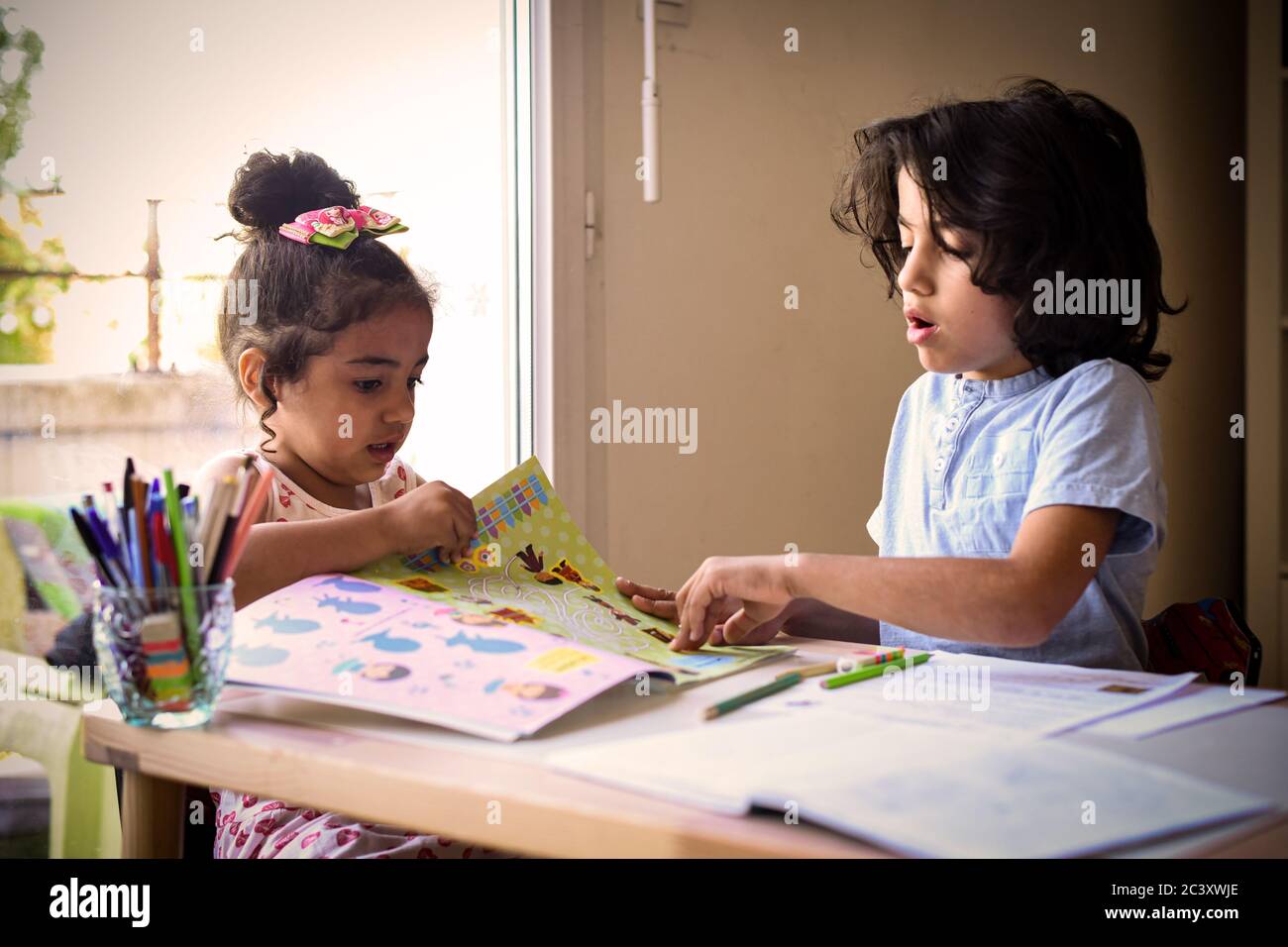 young children doing their homework at home Stock Photo - Alamy