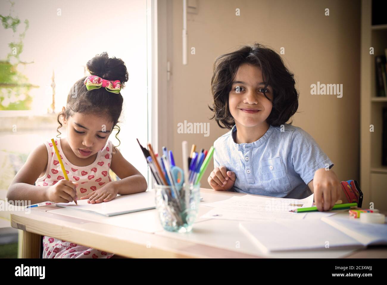 young children doing their homework at home Stock Photo - Alamy