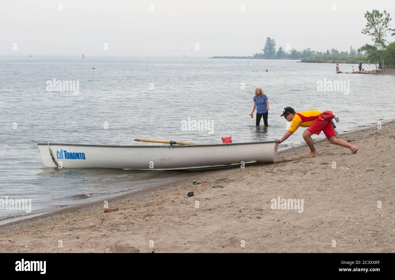 Toronto, Canada. 22nd June, 2020. A lifeguard pushes a lifeboat into ...