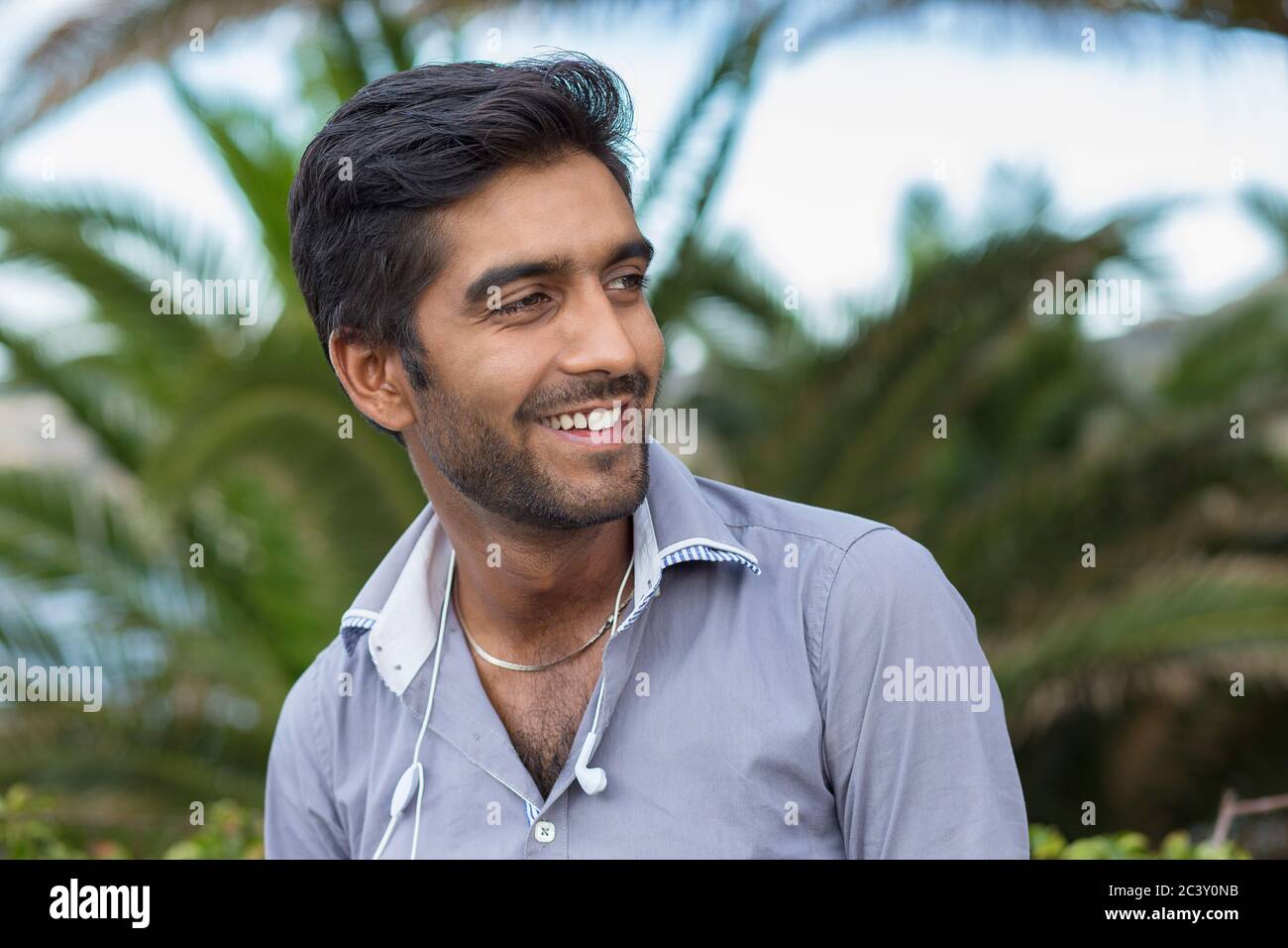 Smiling happily man with cheerful face expression standing outdoors in ...