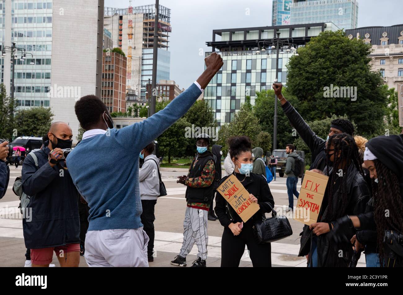 Protesters raising the fists and with placards ...