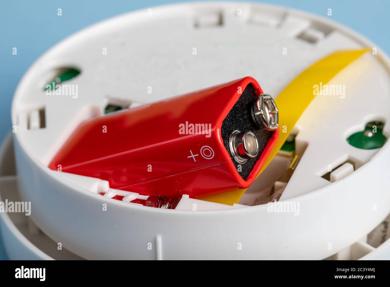 a smoke and fire detector showing the battery being installed Stock ...