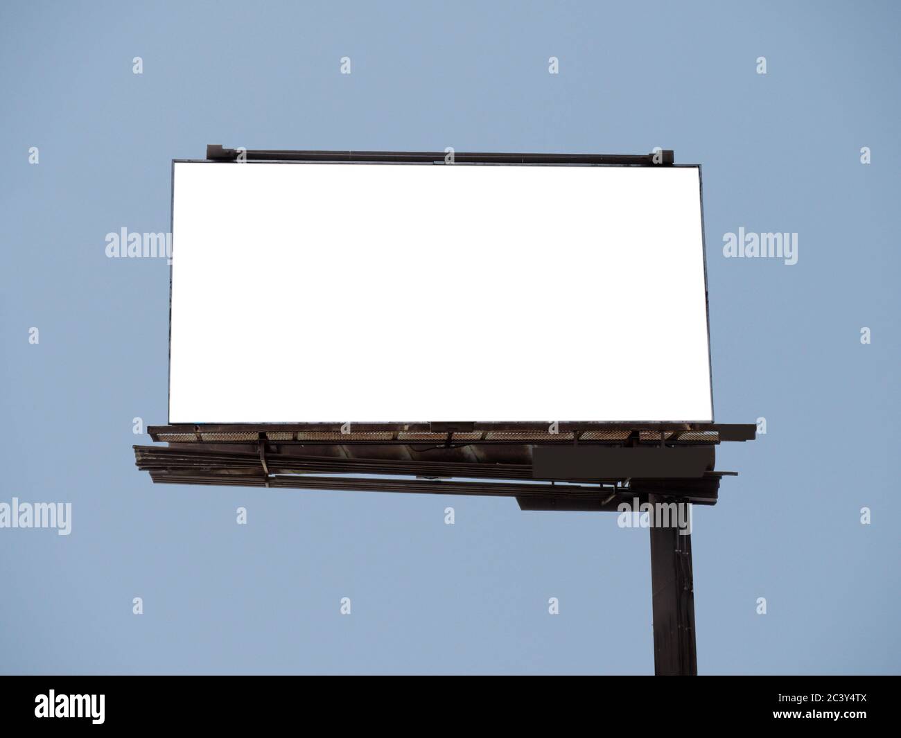 an anonymous blank billboard on a blue sky background with copy space ...