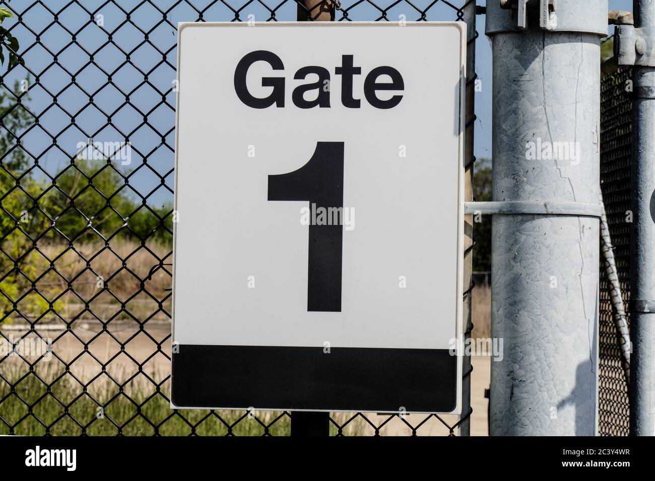 a sign indicating Gate 1 on a chain link fence Stock Photo - Alamy