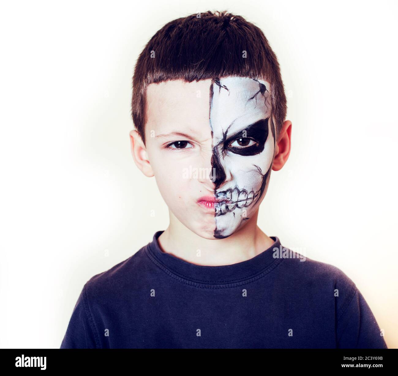 little cute boy with facepaint like skeleton to celebrate halloween ...