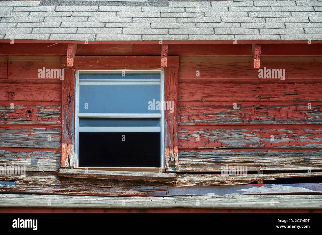 Window of an old abandoned and weathered red barn. Closeup Stock Photo ...