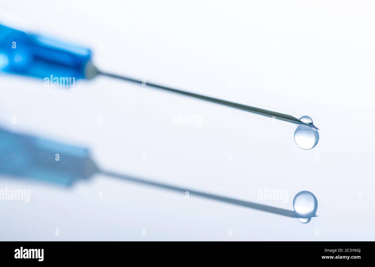 Liquid drop on top of syringe needle Stock Photo - Alamy