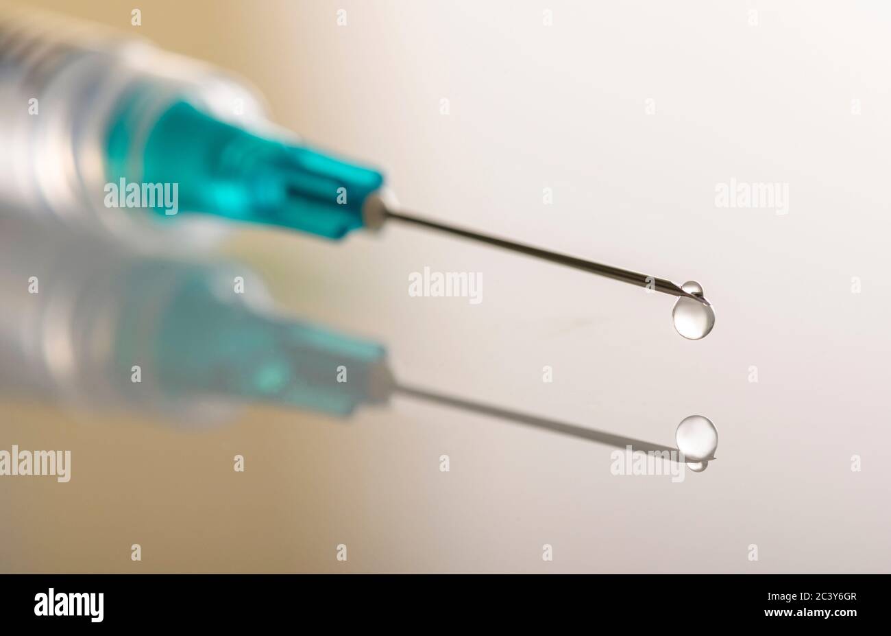 Liquid drop on top of syringe needle Stock Photo - Alamy