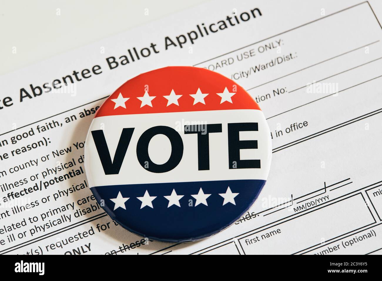 Vote pin on absentee ballot application Stock Photo - Alamy