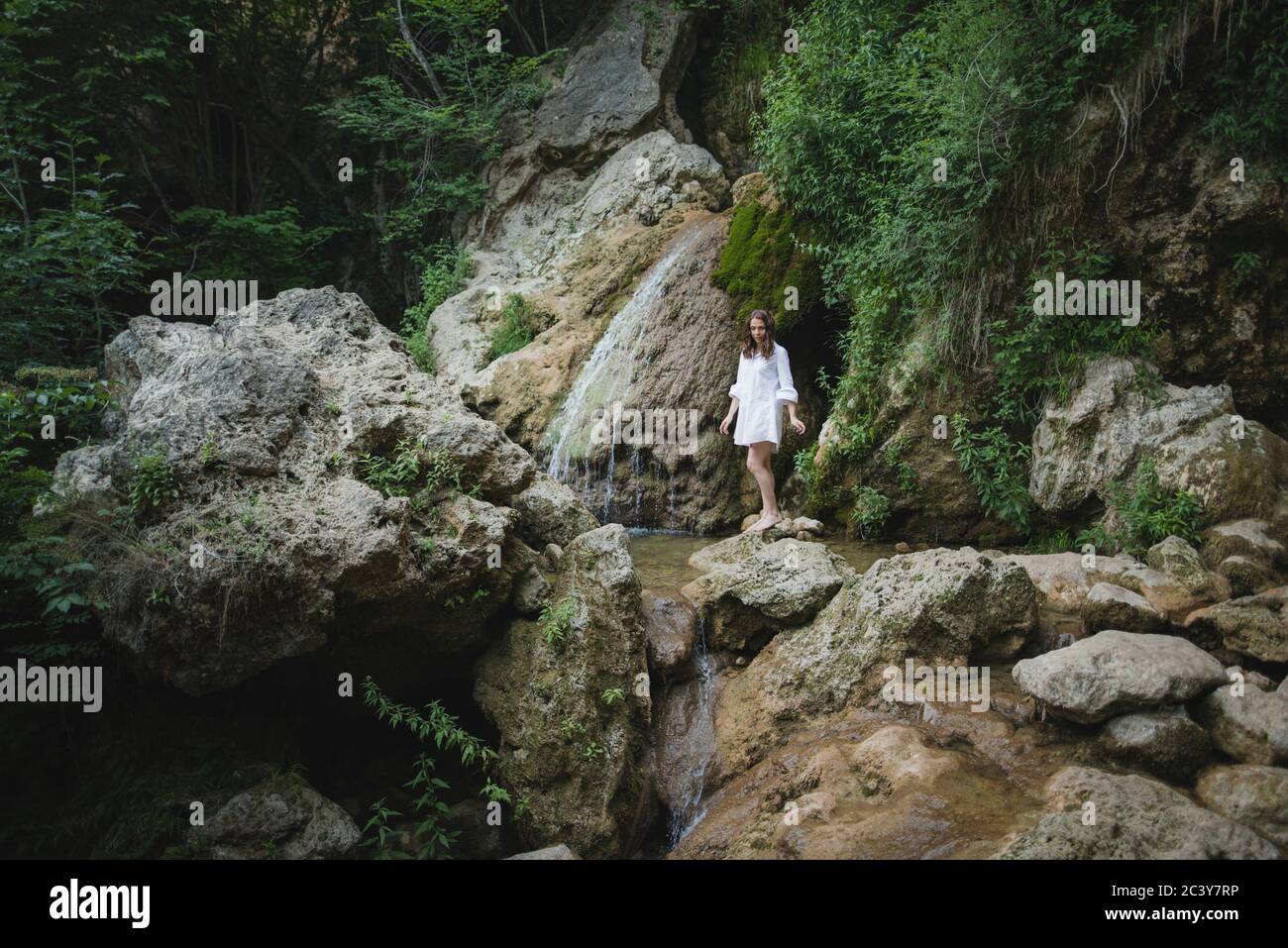 Ukraine, Crimea, Young woman walking barefoot on rocks in canyon Stock ...