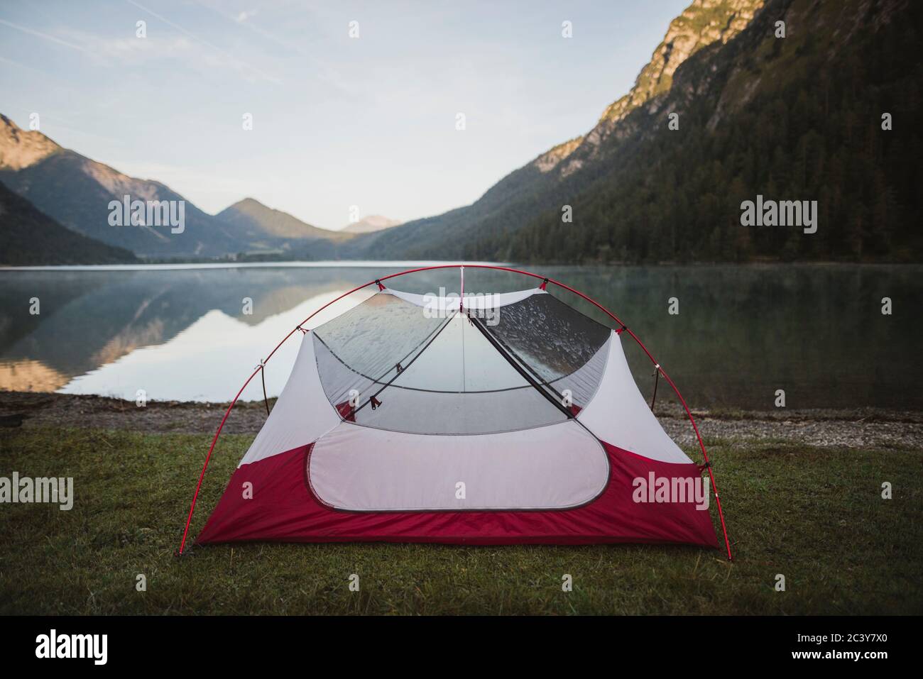 Austria, Plansee, Tent by lake Plansee in Austrian Alps at sunrise ...