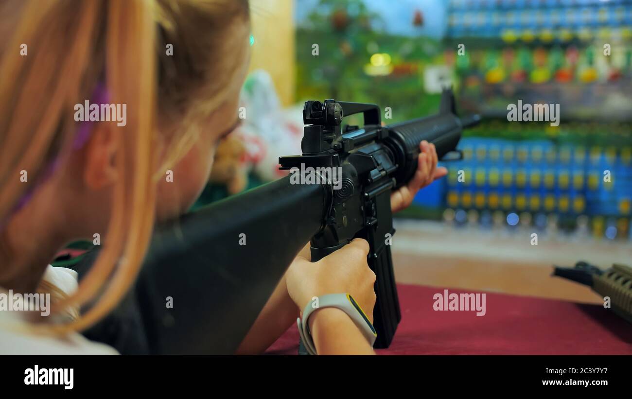 Girl teenager with a gun shoots at a shooting range Stock Photo - Alamy