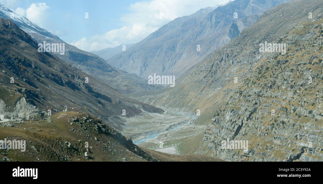 V-shaped Himalayas valley down which a river with a winding course ...