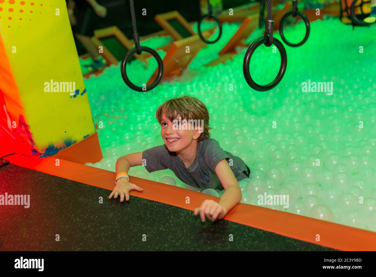 Boy doing an indoor obstacle course Stock Photo - Alamy
