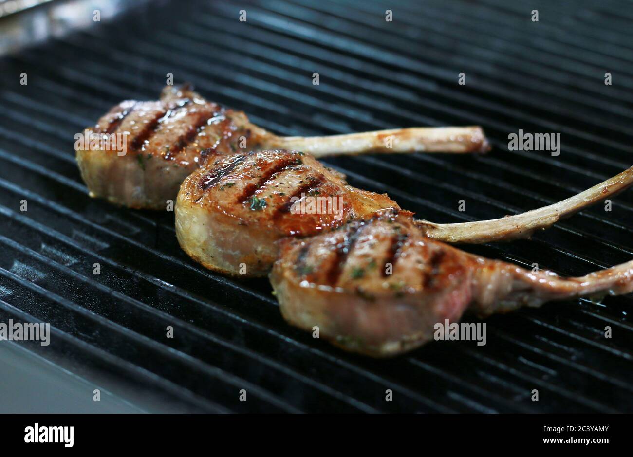 Three beef bone in rib eye steak with grill marks on grill Stock Photo ...