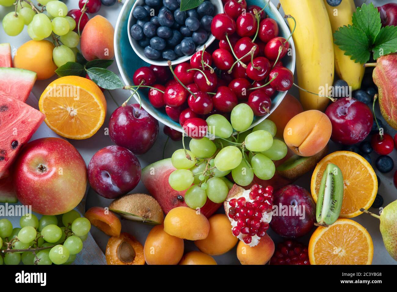 Fresh healthy fruits on grey background. Foods high in antioxidants ...