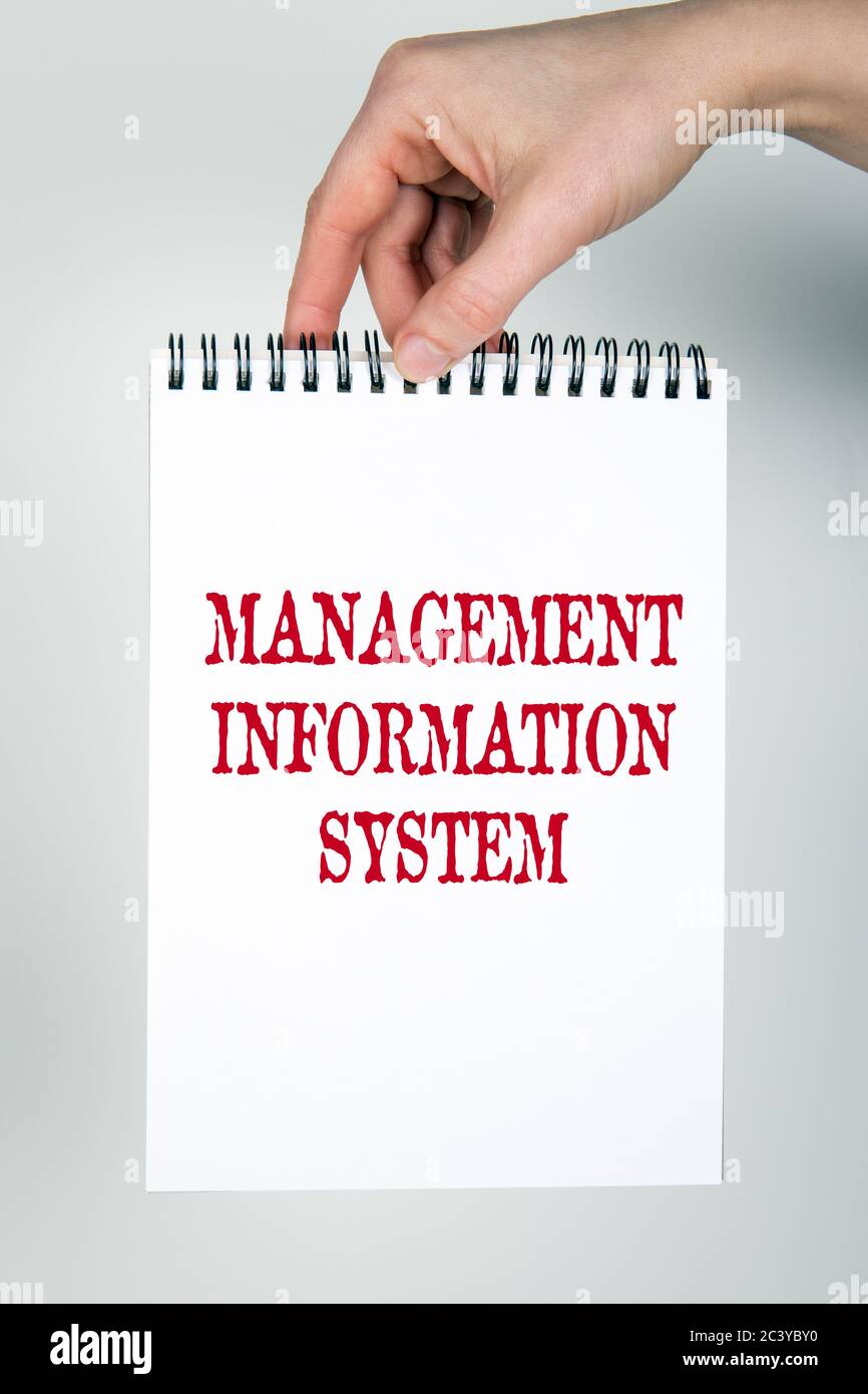 MANAGEMENT INFORMATION SYSTEM concept. Note book with text in the hand ...