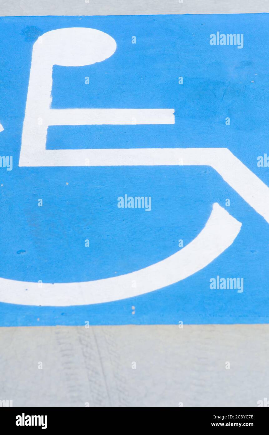 Close up detail of white on blue Handicapped in wheelchair sign and ...