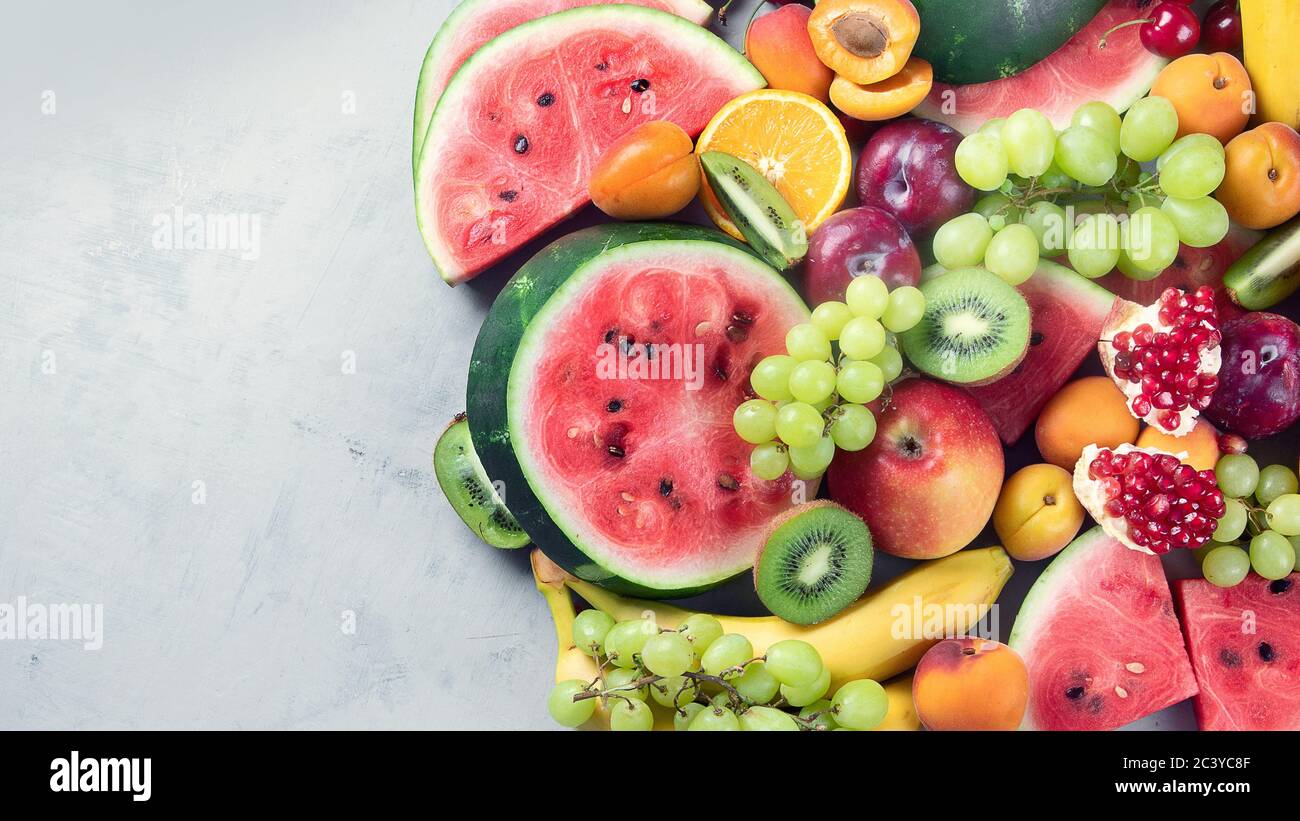 Fresh healthy fruits on grey background. Foods high in antioxidants ...