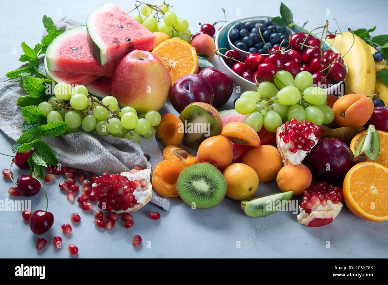 Fresh healthy fruits on grey background. Foods high in antioxidants ...