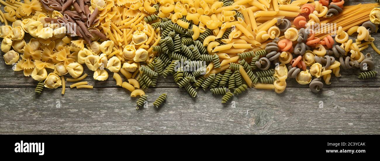 Different type of pasta on wooden rustic background. Diet food concept ...