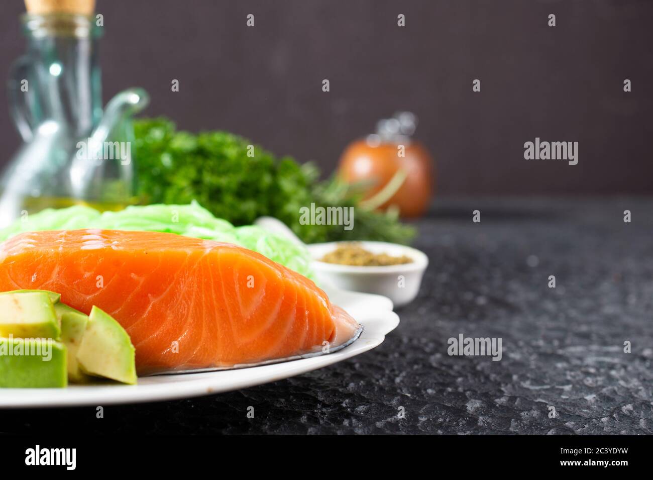 Raw Salmon with Avocado on plate, diet food Stock Photo - Alamy