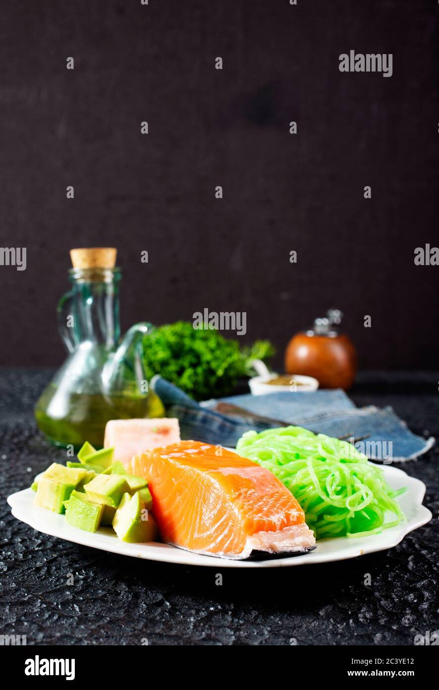 Raw Salmon with Avocado on plate, diet food Stock Photo - Alamy