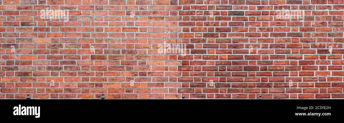 Panorama of large red brick wall with white grouting. Textured old ...