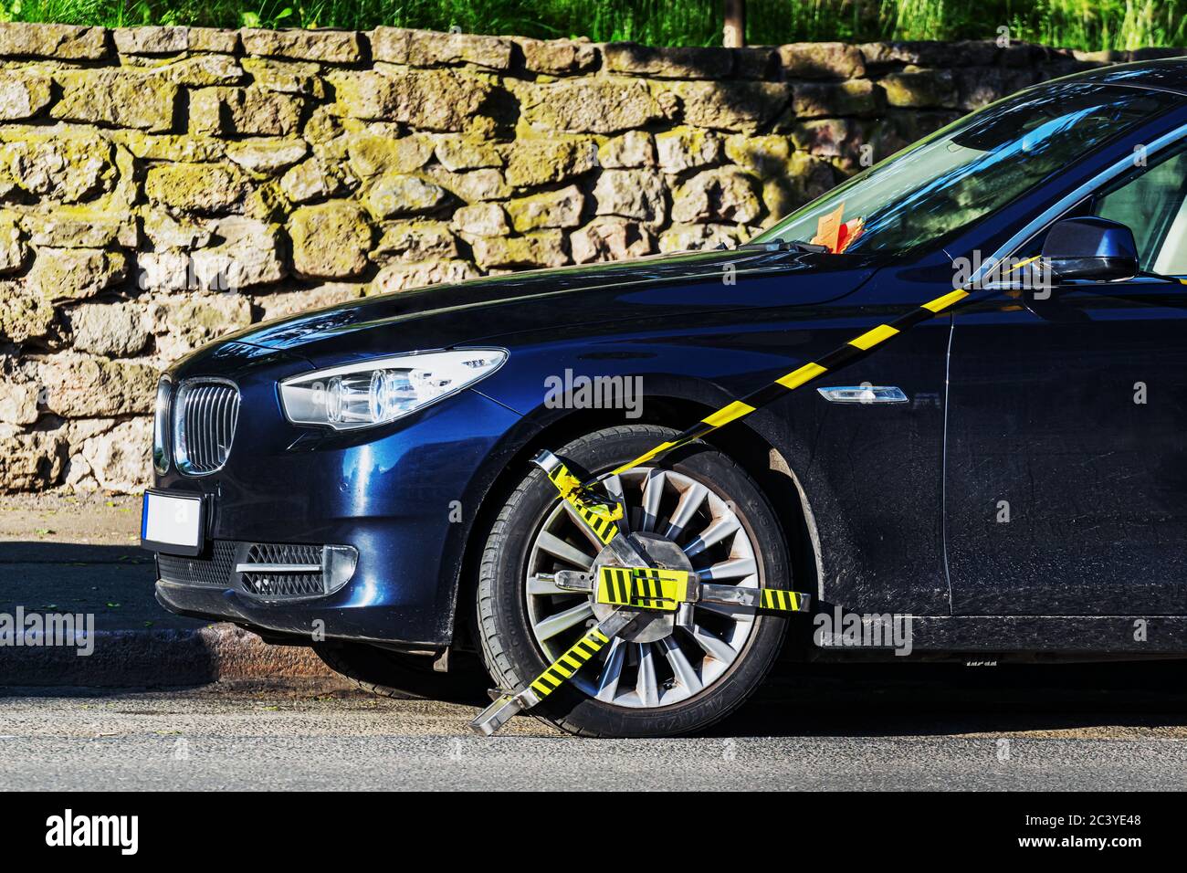 Car was locked with clamped vehicle, wheel lock. Clamped front wheel of ... Car was locked with clamped vehicle, wheel lock. Clamped front wheel of ...