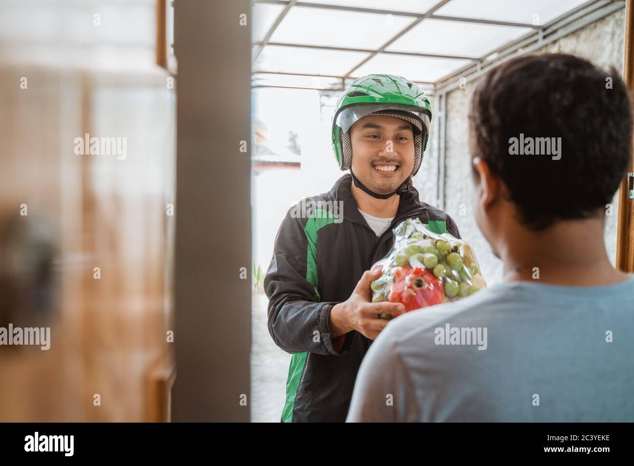 portrait of asian delivery man delivering fruit parcel Stock Photo - Alamy