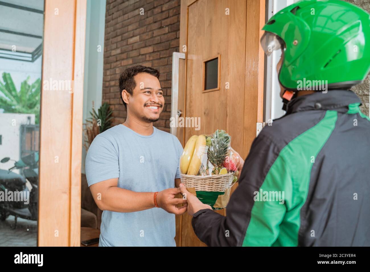 man ordering food online and receive the order at home delivered by ...