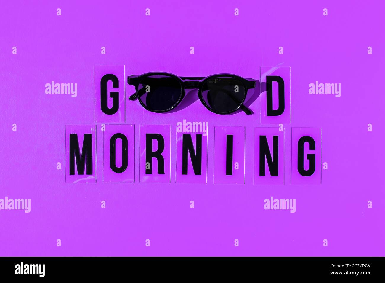 Sunglasses on Purple blue background and text GOOD MORNING. Top view ...