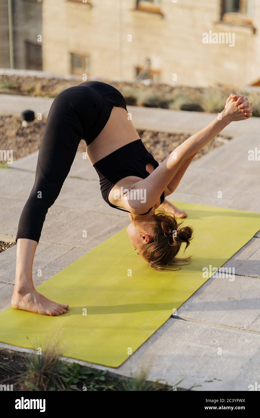 Young girl practicing stretching and yoga workout exercise on the ...