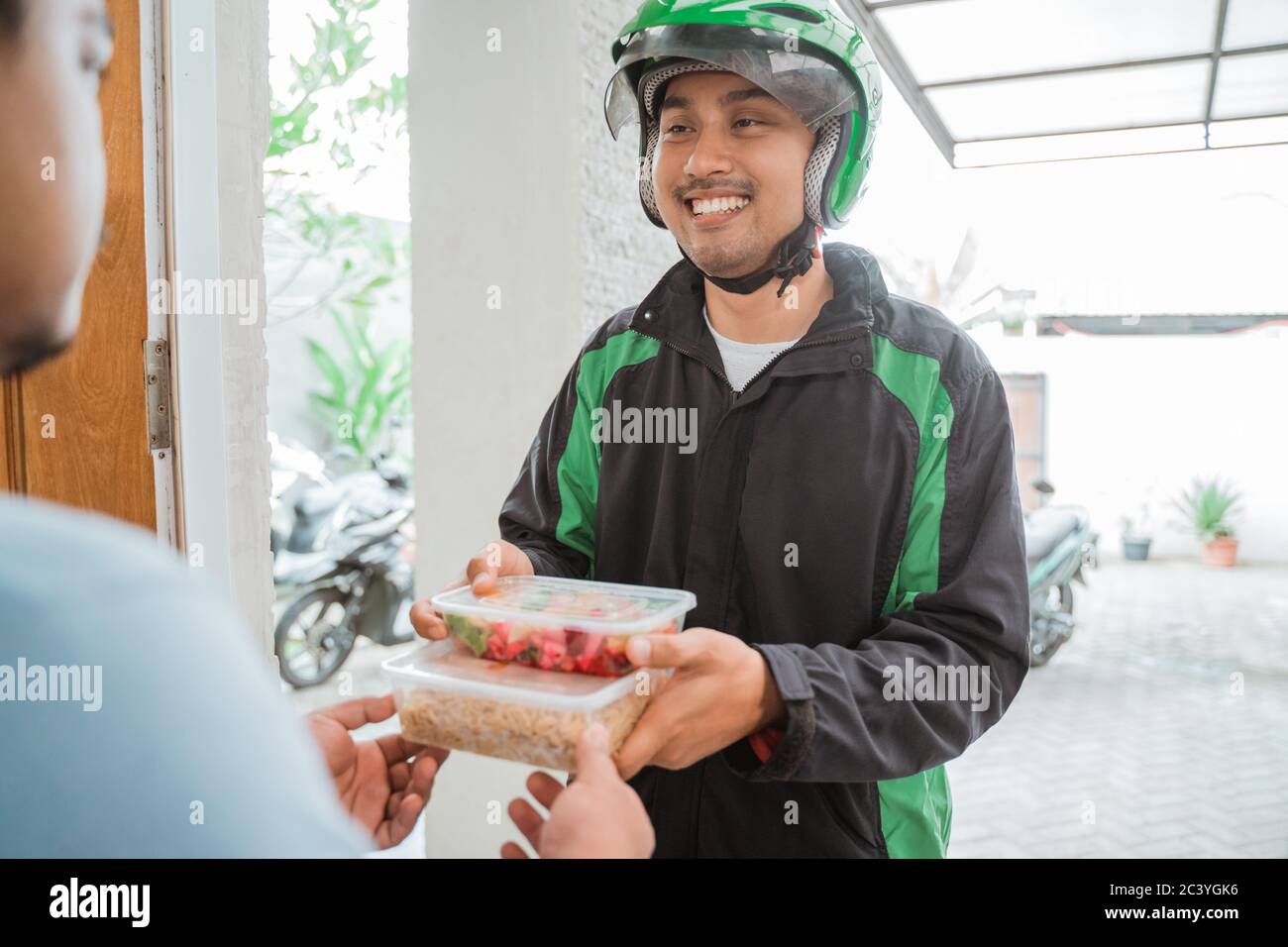 man ordering food online and receive the order at home delivered by ...