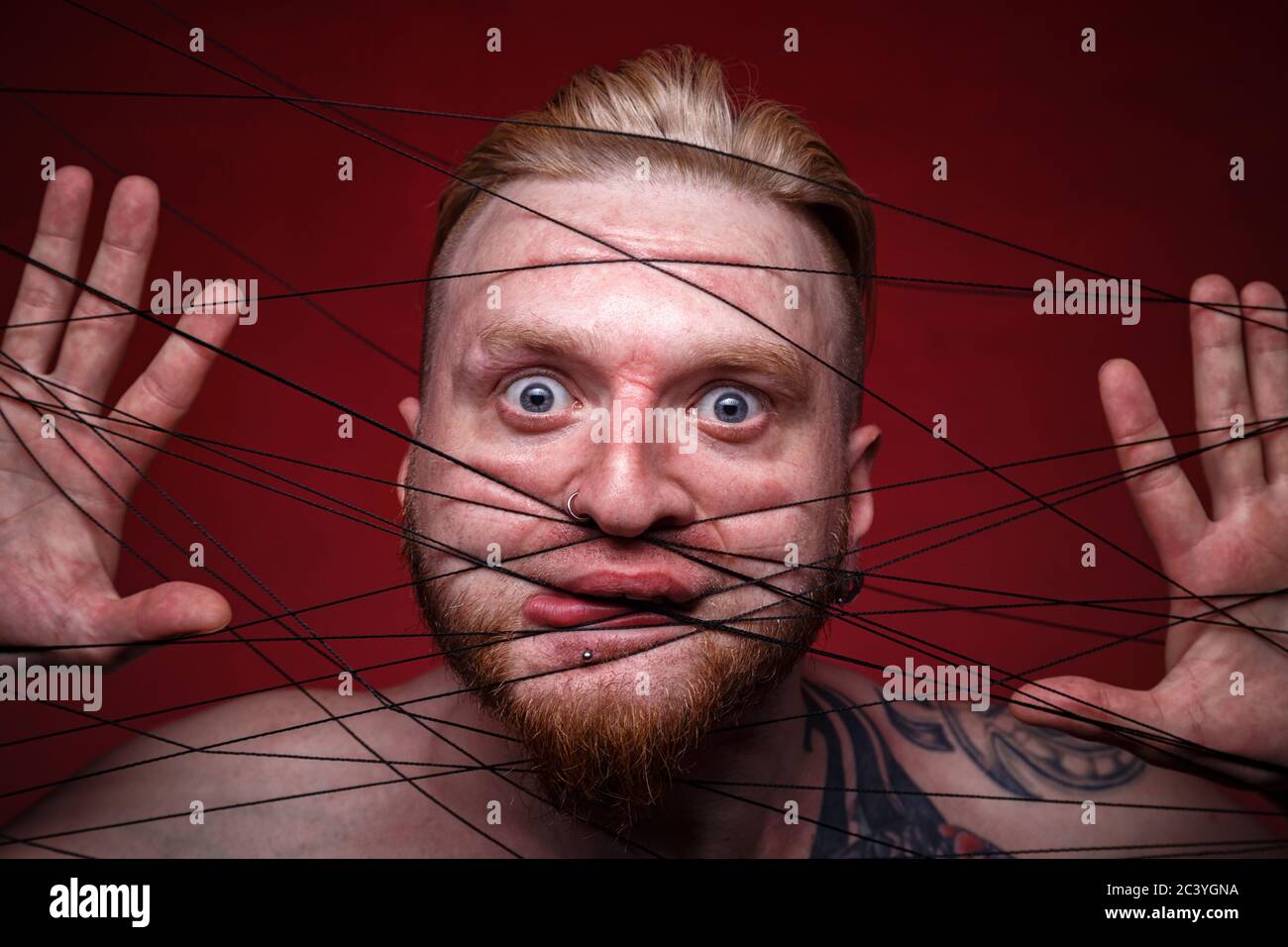 Photo of tangled in black threads scared man Stock Photo - Alamy
