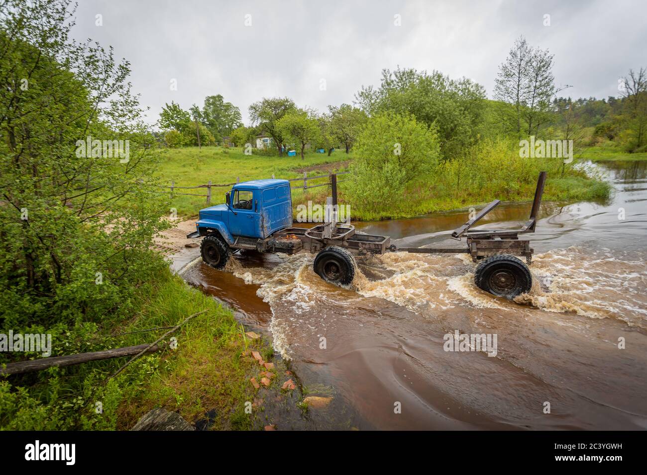 timber truck crosses the ford river Stock Photo - Alamy